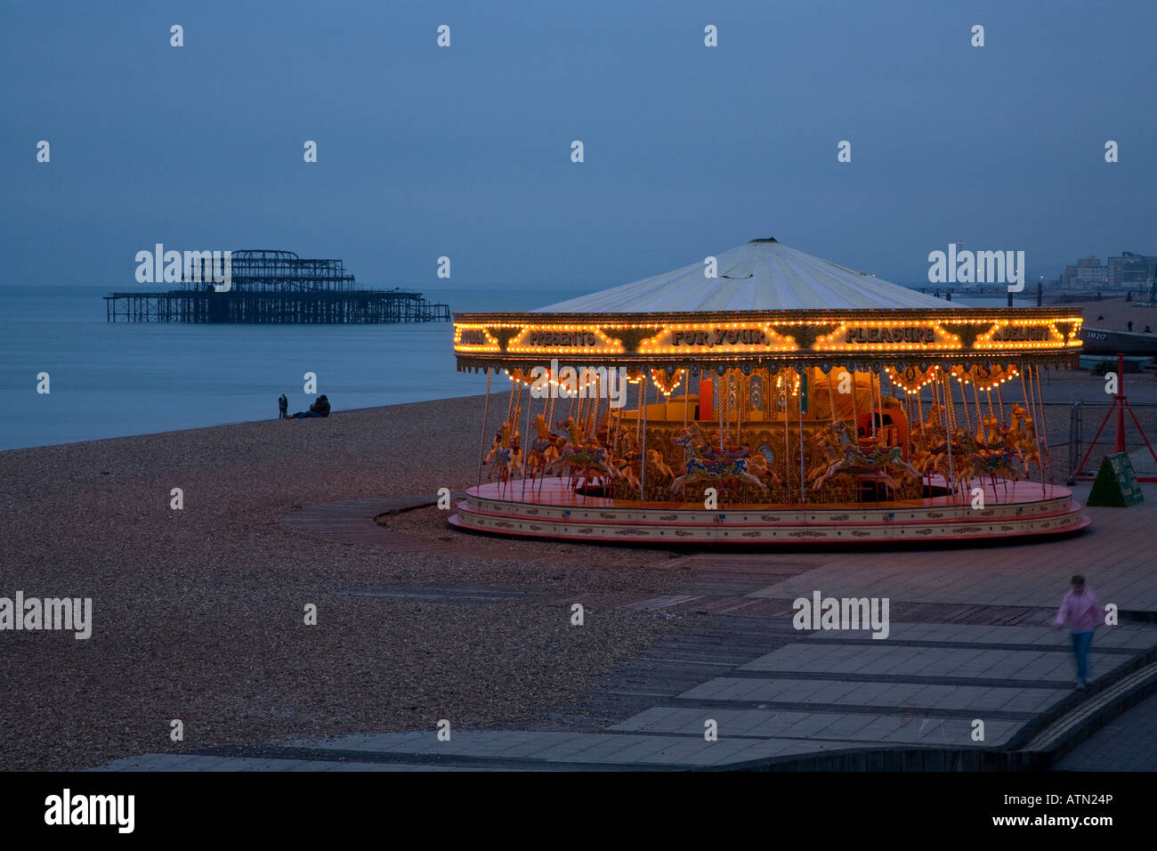 Well lit carousel welcomes daytripper to the English coastal town of ...