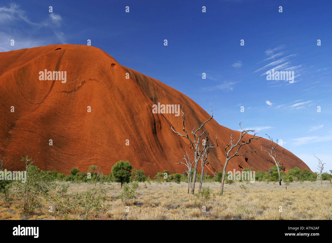 Side view of Ayers rock Uluru in early morning sunlight and shadows ...