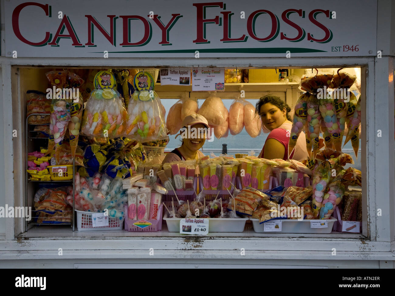 Sweets stand selling Candy Floss and other candies with two young women ...
