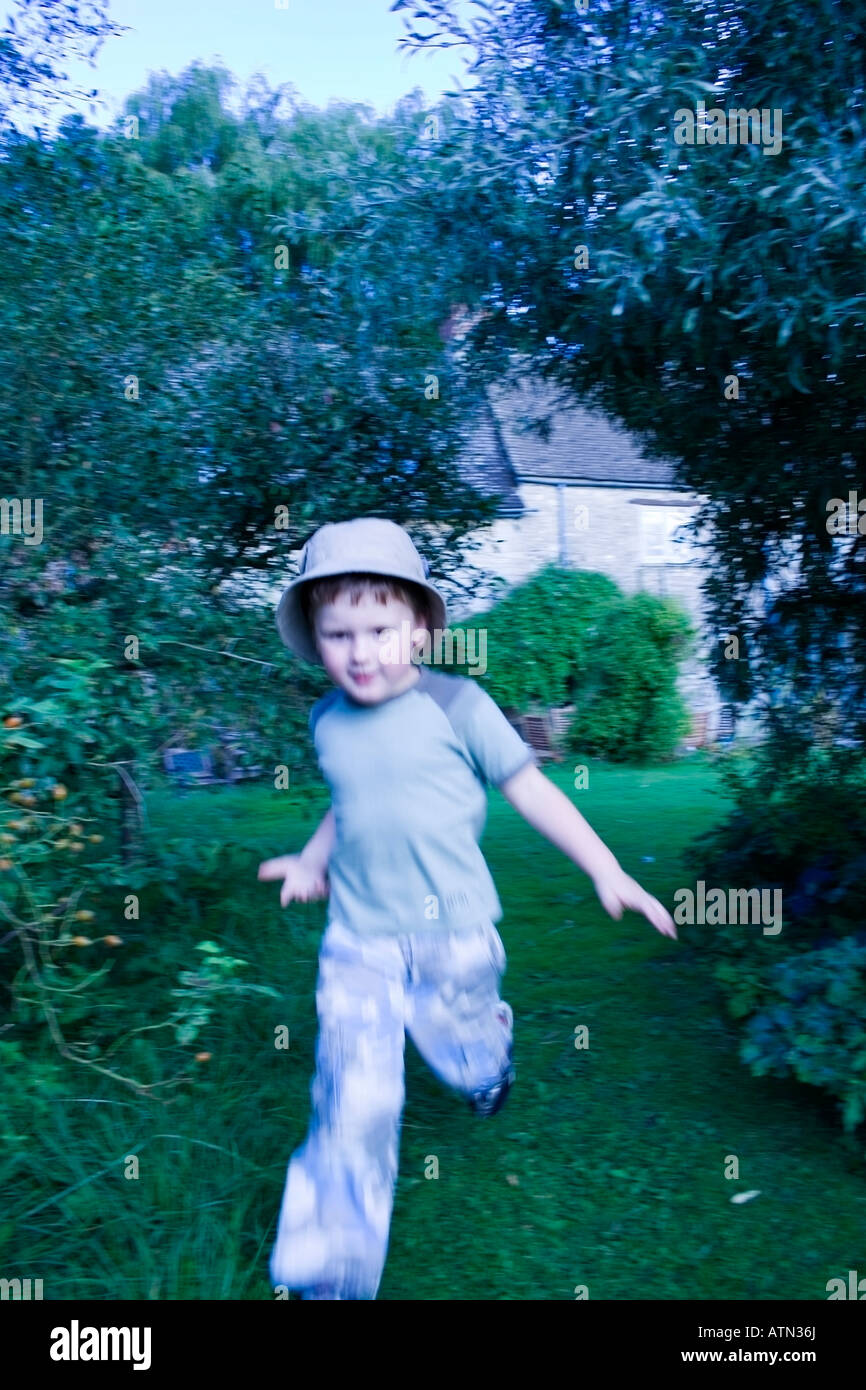 boy running fast towards camera causing movement blur Stock Photo - Alamy