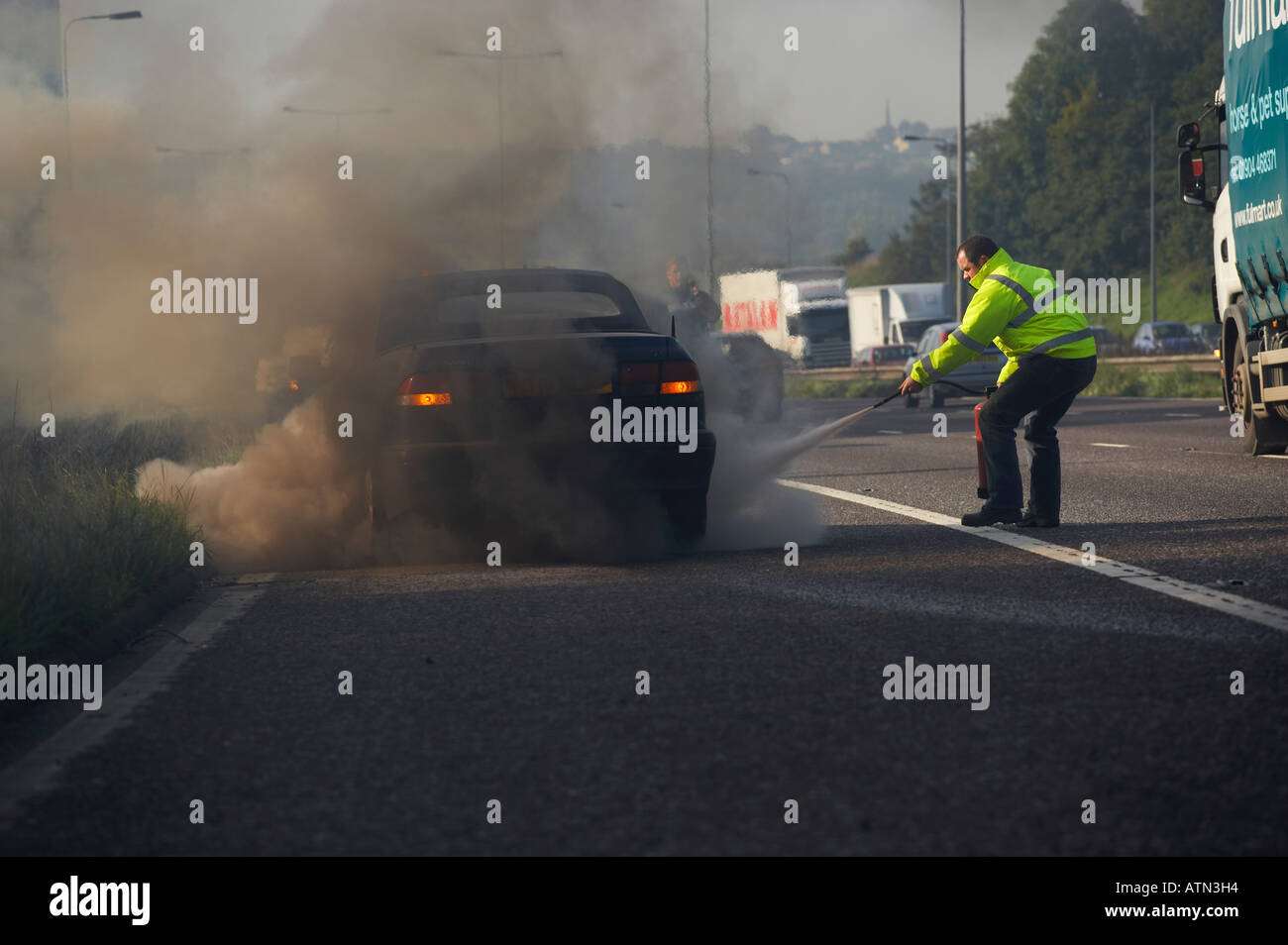 EMERGENCY SERVICES USING FIRE EXTINGUISHER ON BURNING CAR ON M62 ...