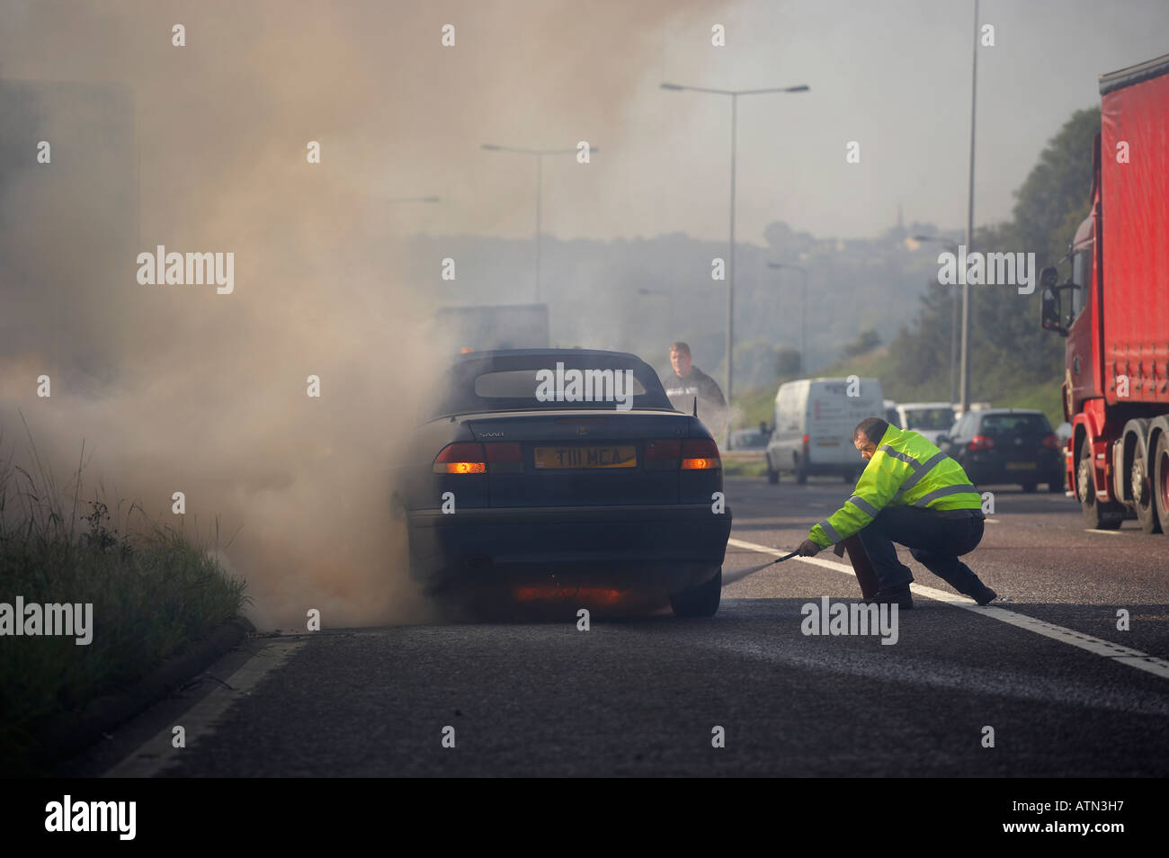 EMERGENCY SERVICES USING FIRE EXTINGUISHER ON BURNING CAR ON M62 ...