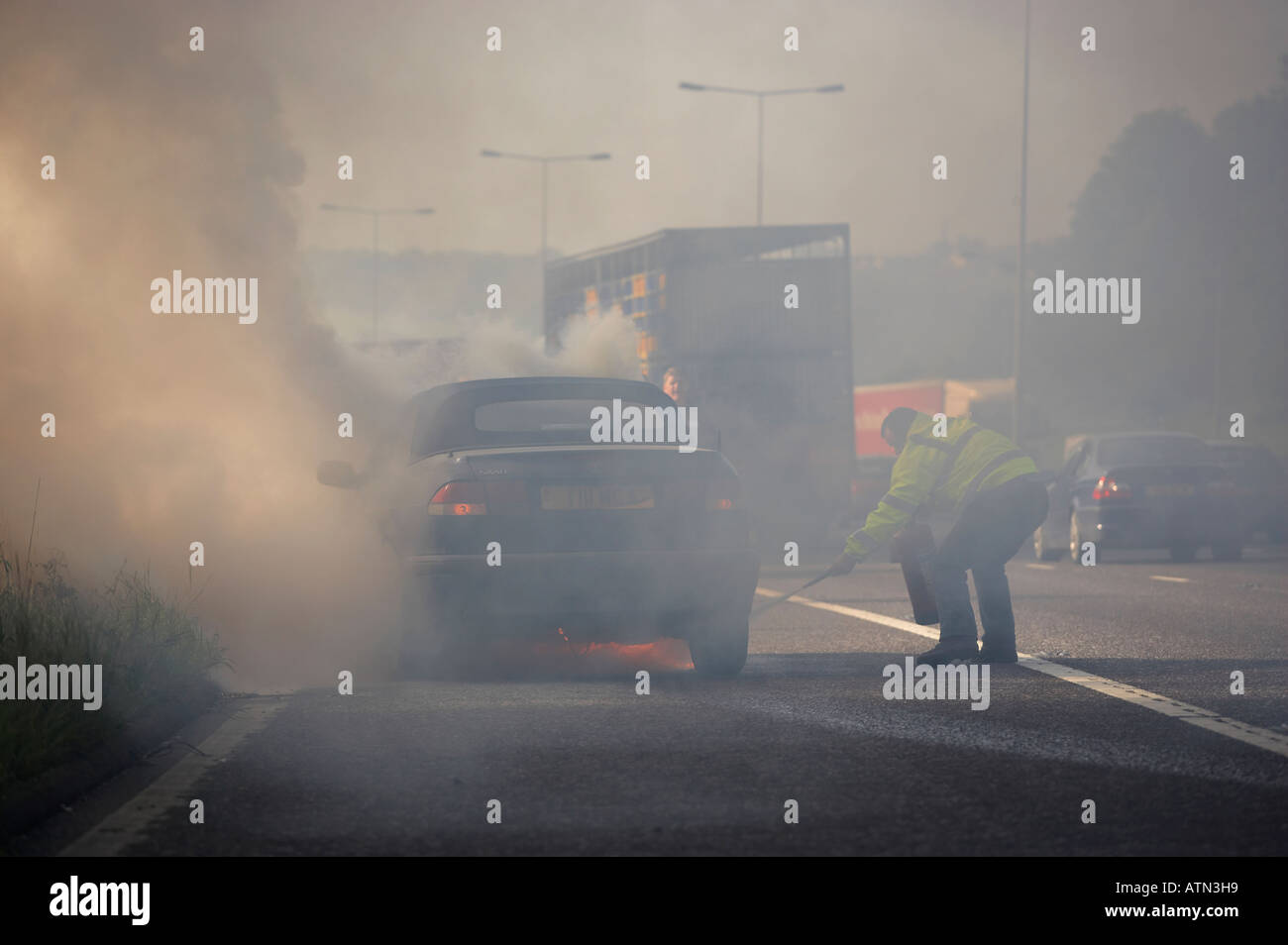 EMERGENCY SERVICES USING FIRE EXTINGUISHER ON BURNING CAR ON M62 ...