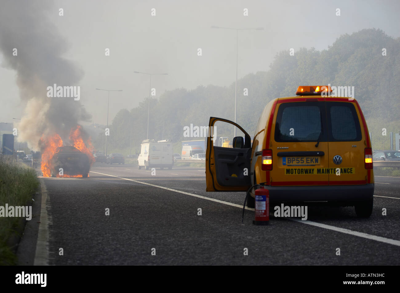 EMERGENCY SERVICES VEHICLE WITH FIRE EXTINGUISHER AT SCENE OF BURNING ...