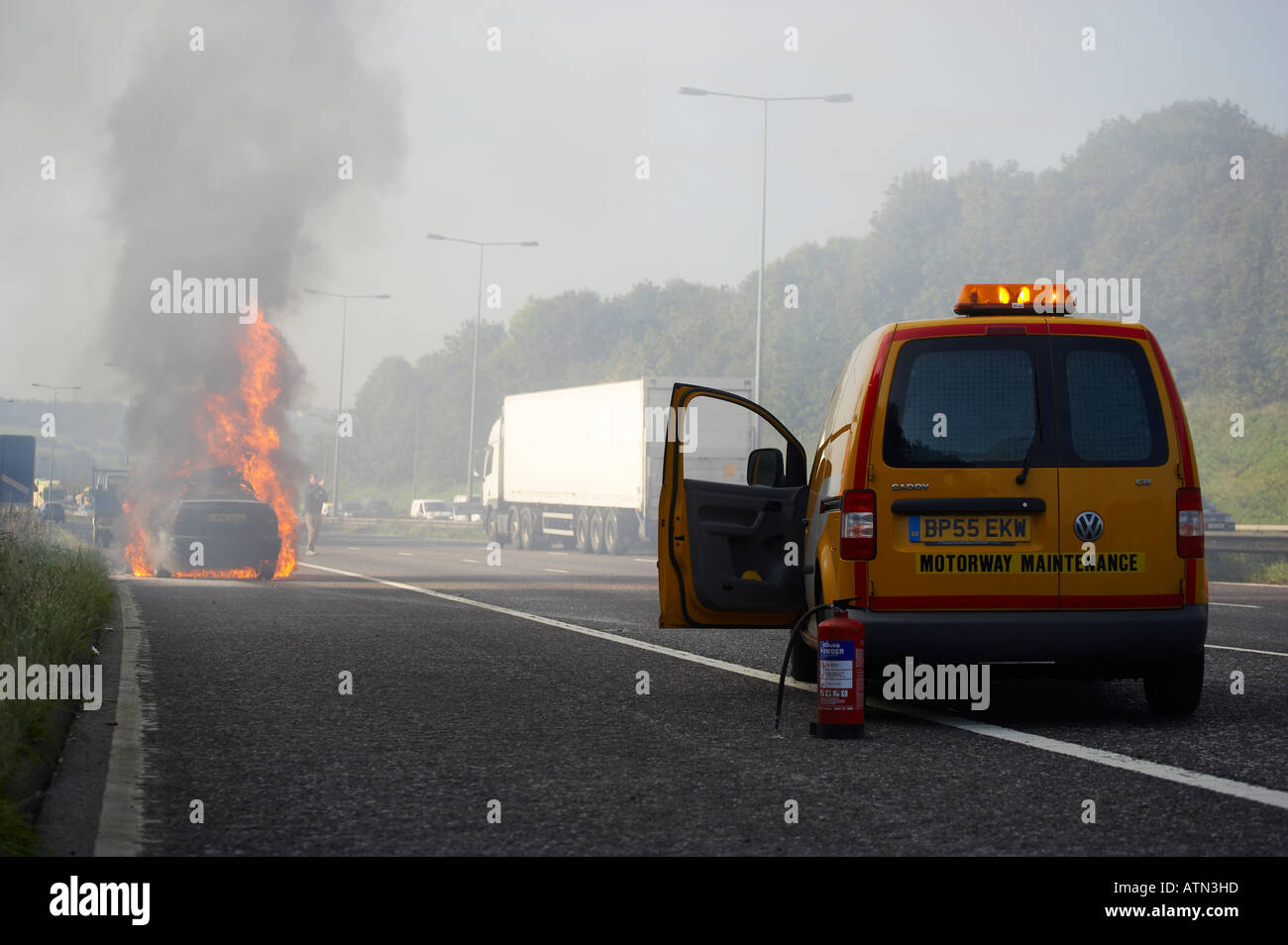EMERGENCY SERVICES VEHICLE WITH FIRE EXTINGUISHER AT SCENE OF BURNING ...