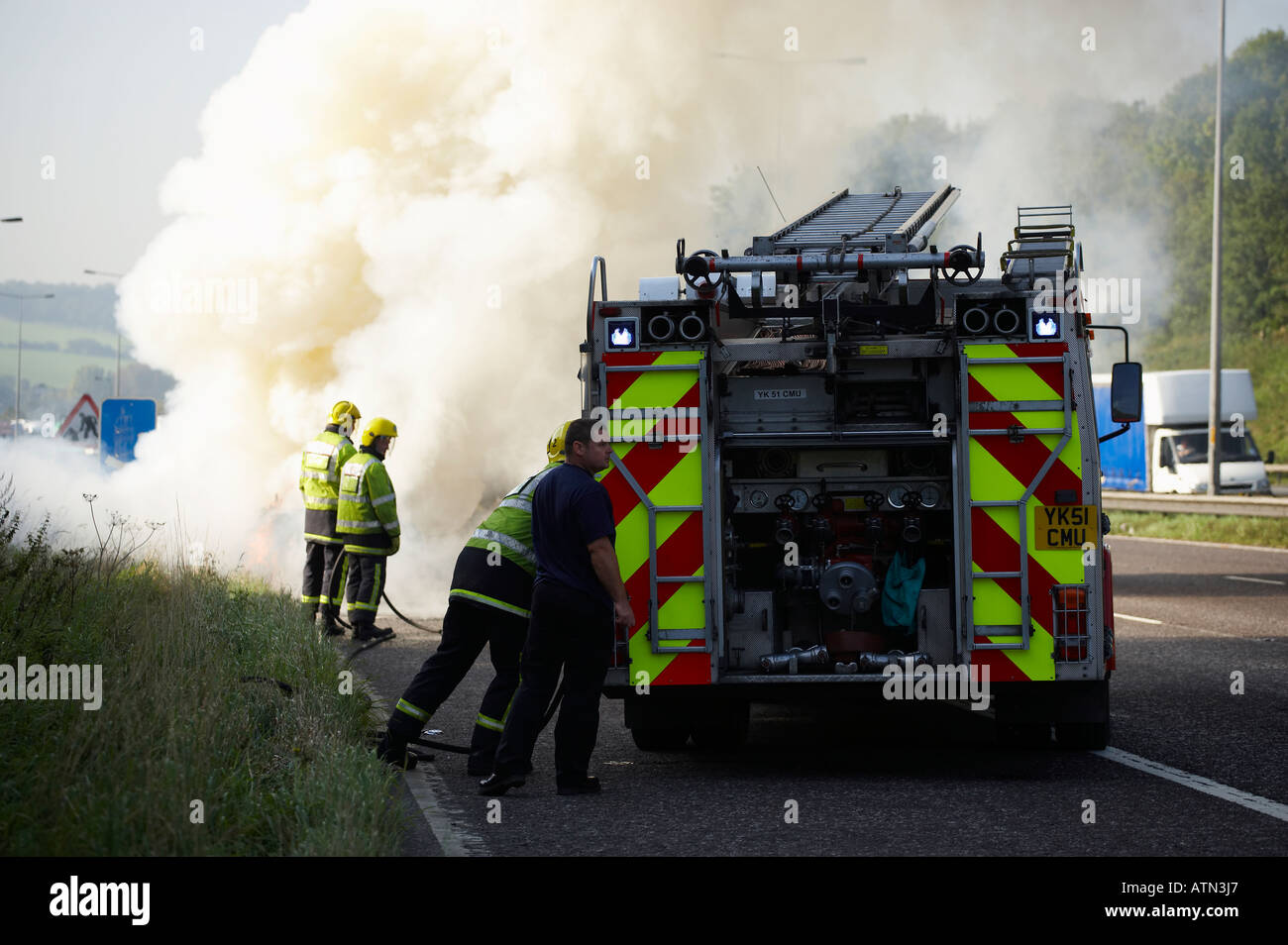 FIRE SERVICE ATTENDING BURNING CAR ON M62 MOTORWAY HARD SHOULDER Stock ...