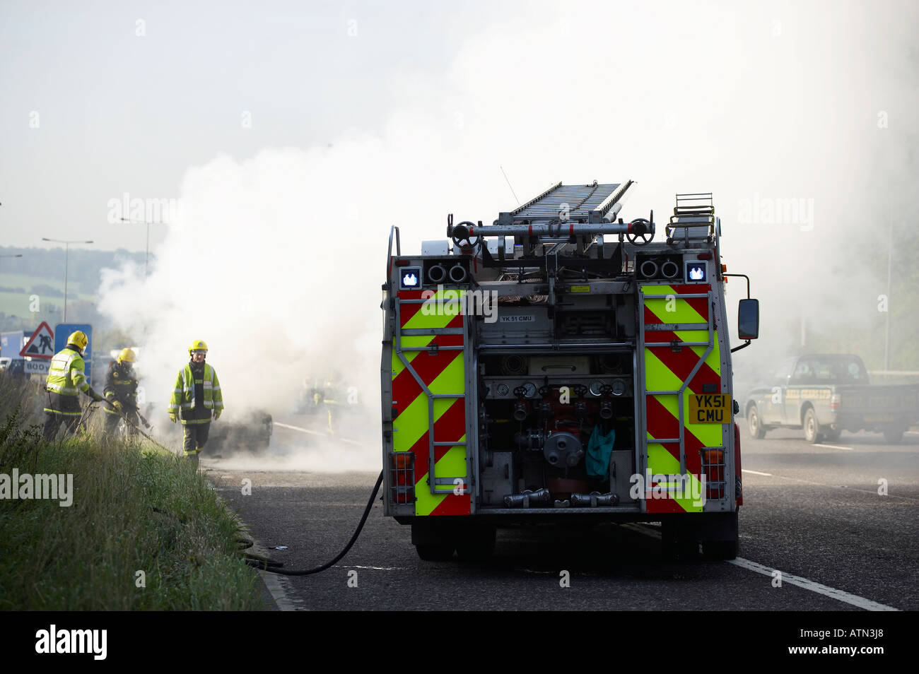 FIRE SERVICE ATTENDING BURNING CAR ON HARD SHOULDER OF M62 MOTORWAY ...