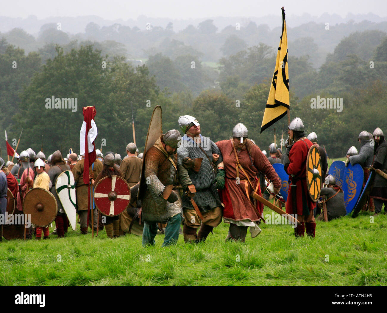 Wounded warrior from Saxon Army helped off the battlefield 1066 Stock ...