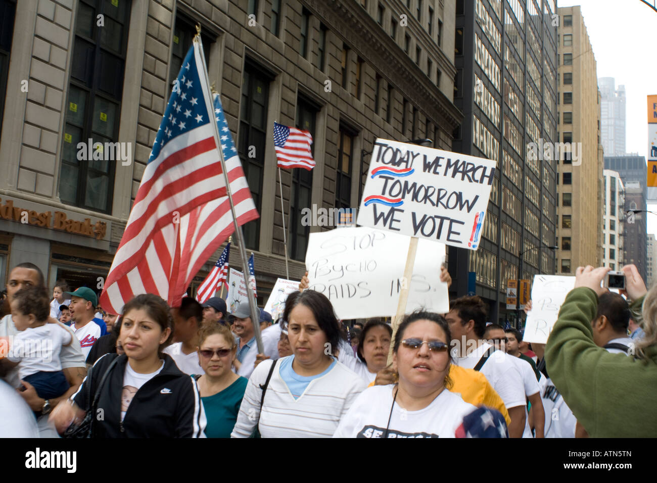 Hispanic workers marching in a protest Chicago Illinois carrying signs ...