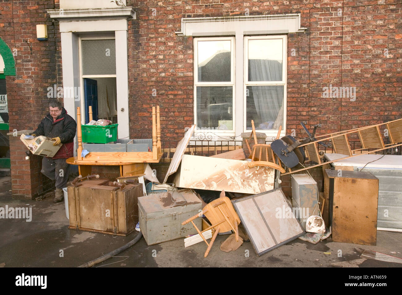 flood damaged property piled up outside flooded out houses in carlisle ...