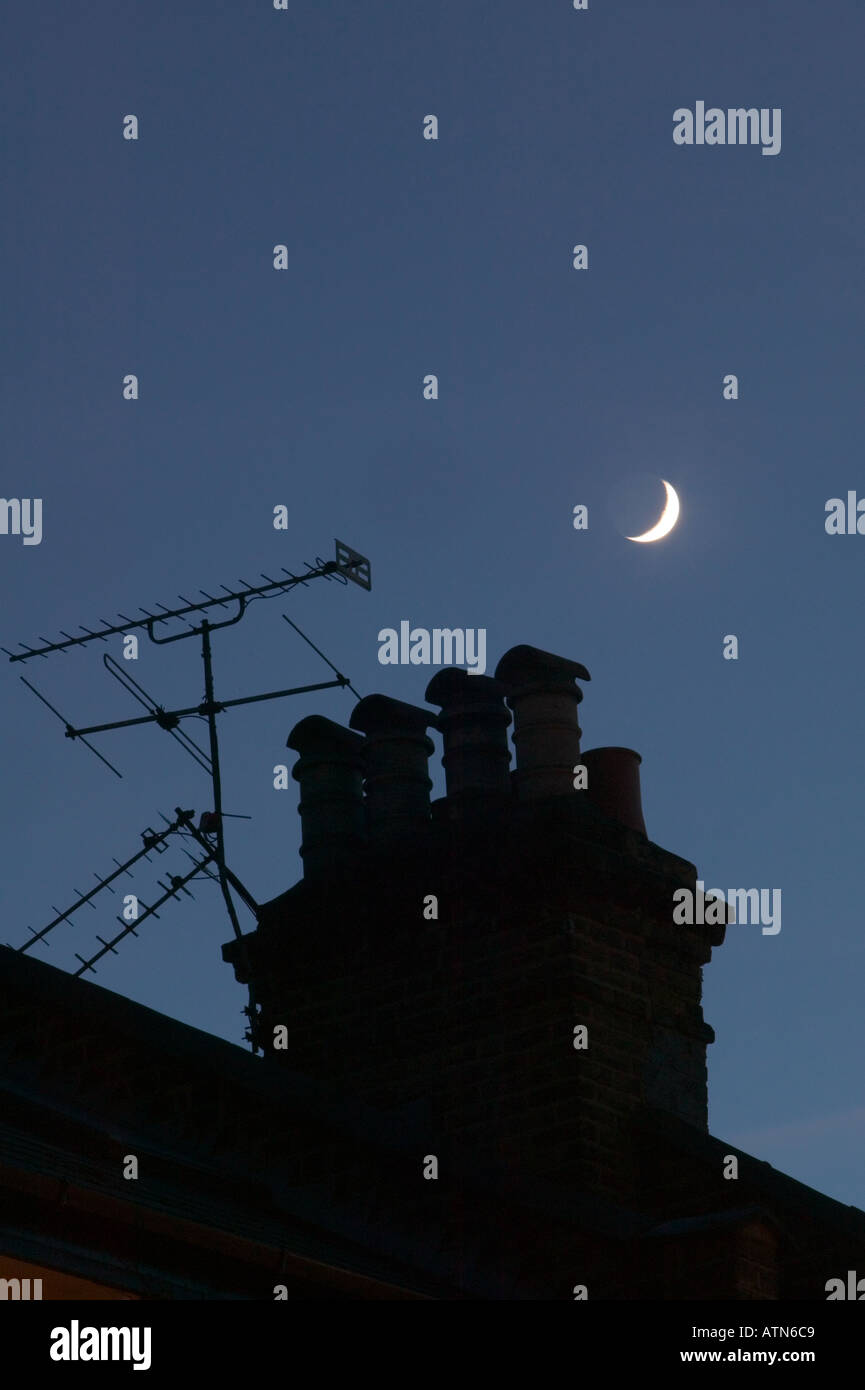 new moon over chimney pot Stock Photo - Alamy