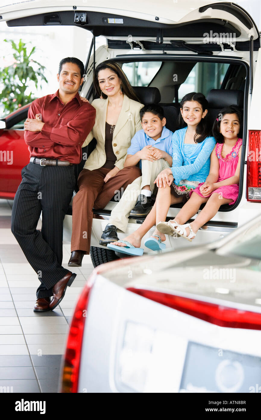 Hispanic family at car dealership Stock Photo - Alamy