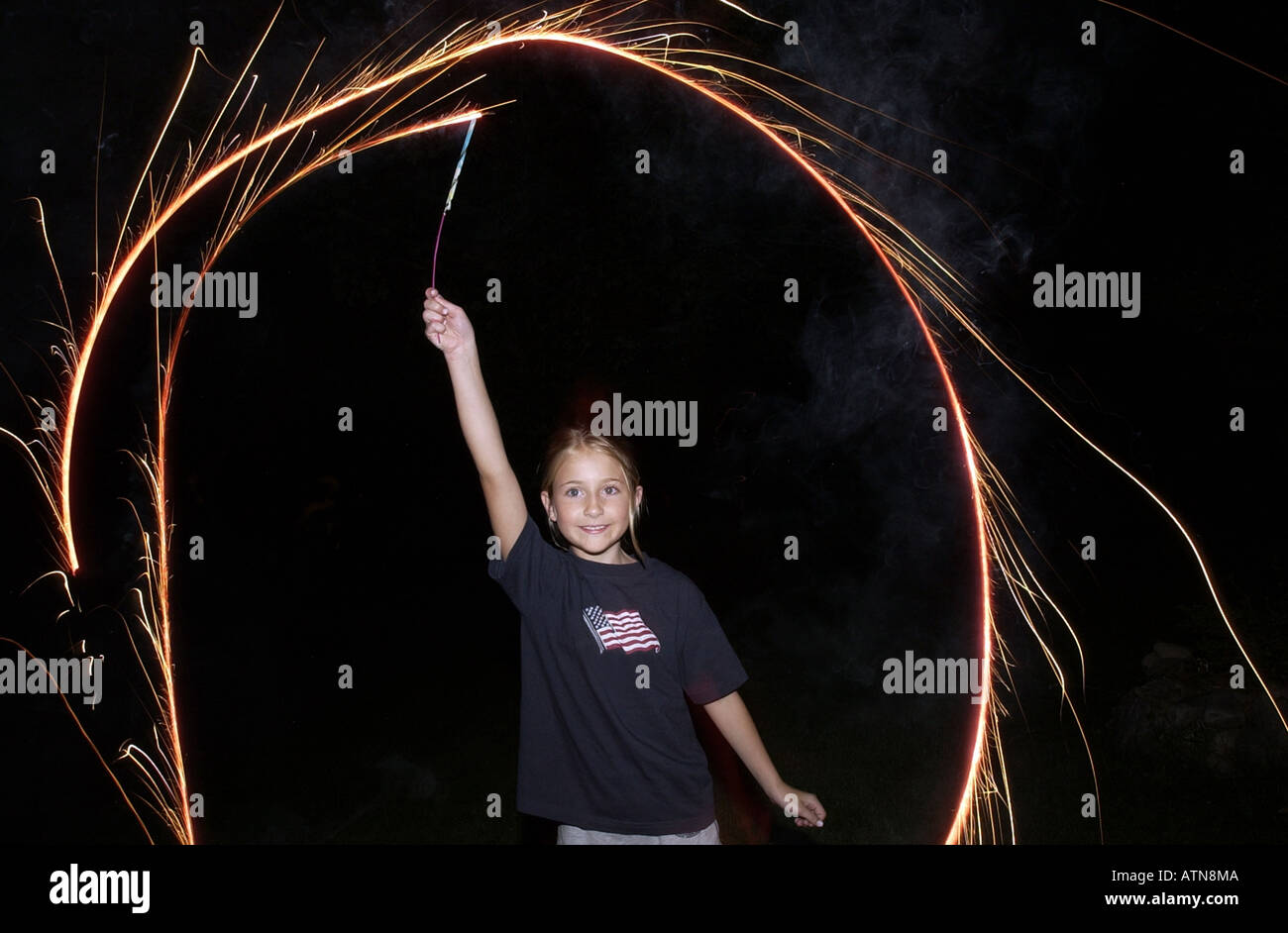 Blonde girl with sparkler PHOTO BOB LUCKEY Stock Photo - Alamy