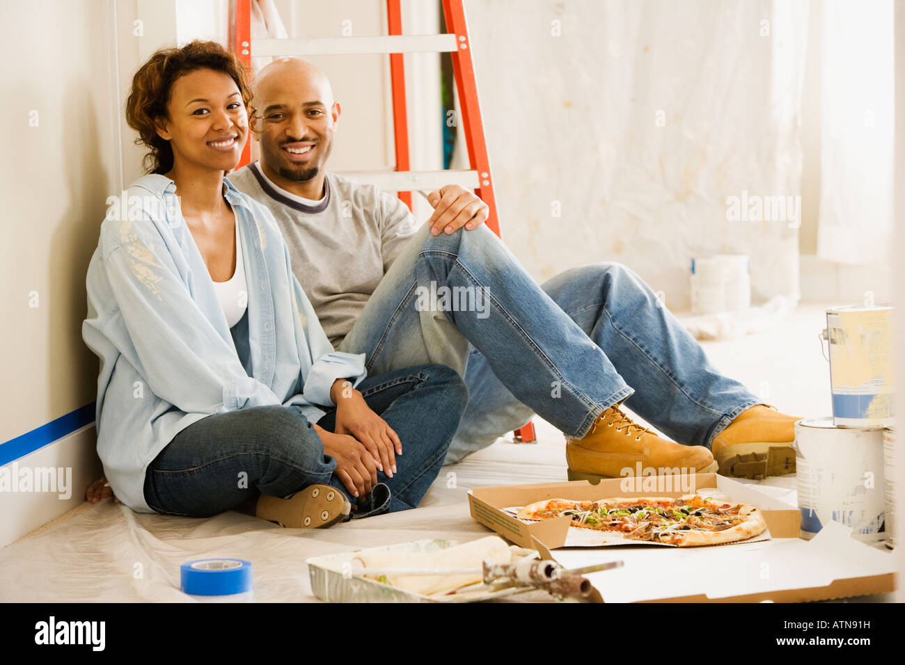 African couple taking lunch break from painting Stock Photo - Alamy