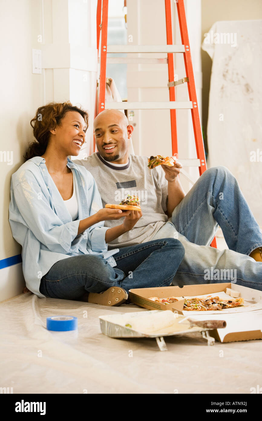 African couple taking lunch break from painting Stock Photo - Alamy