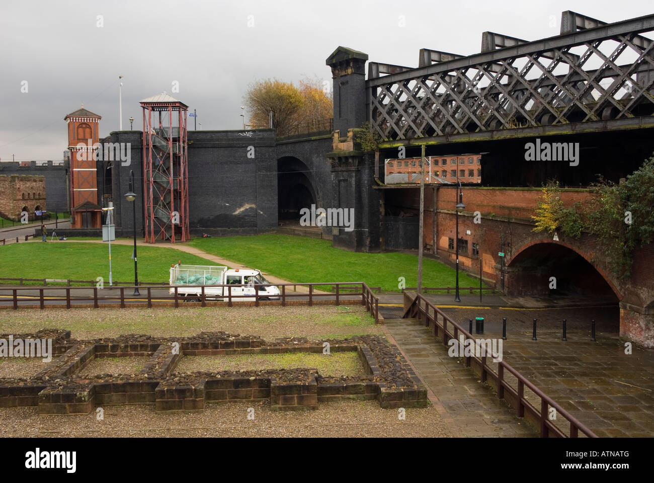 Roman fort leftovers and iron railway bridge in Castlefield, Manchester ...