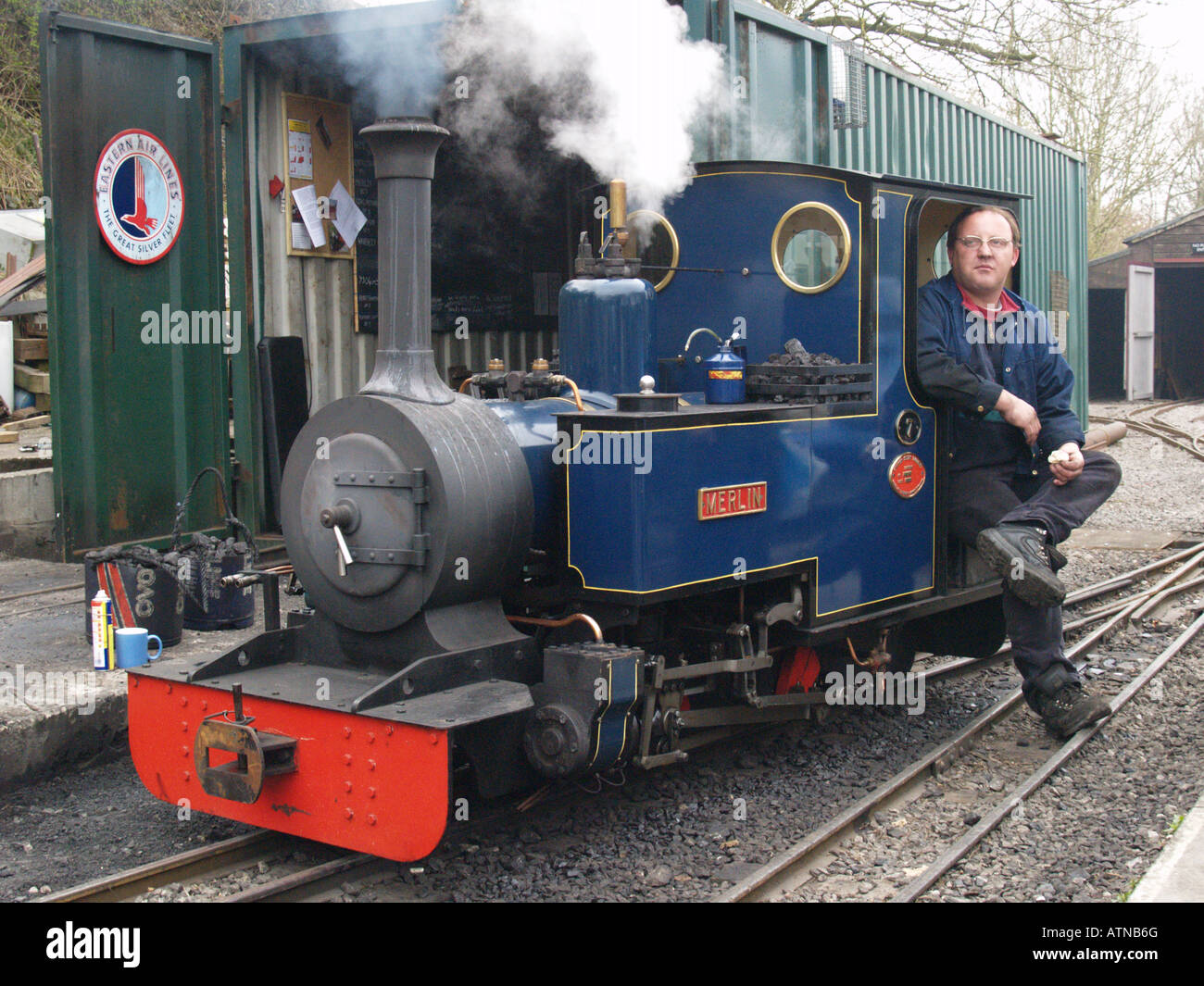 driver resting miniature narrow gauge steam train Stock Photo - Alamy