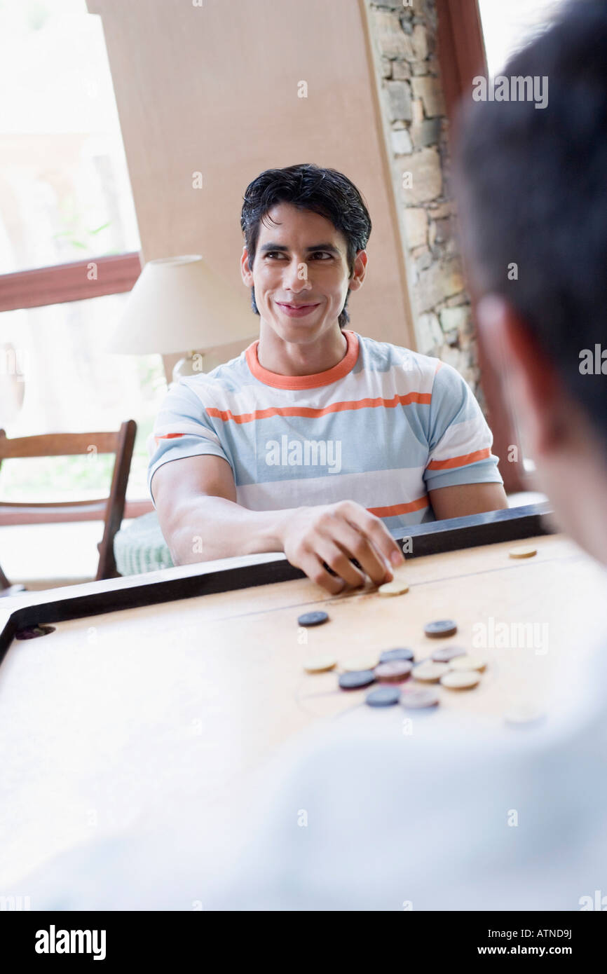 Young man playing carom Stock Photo - Alamy