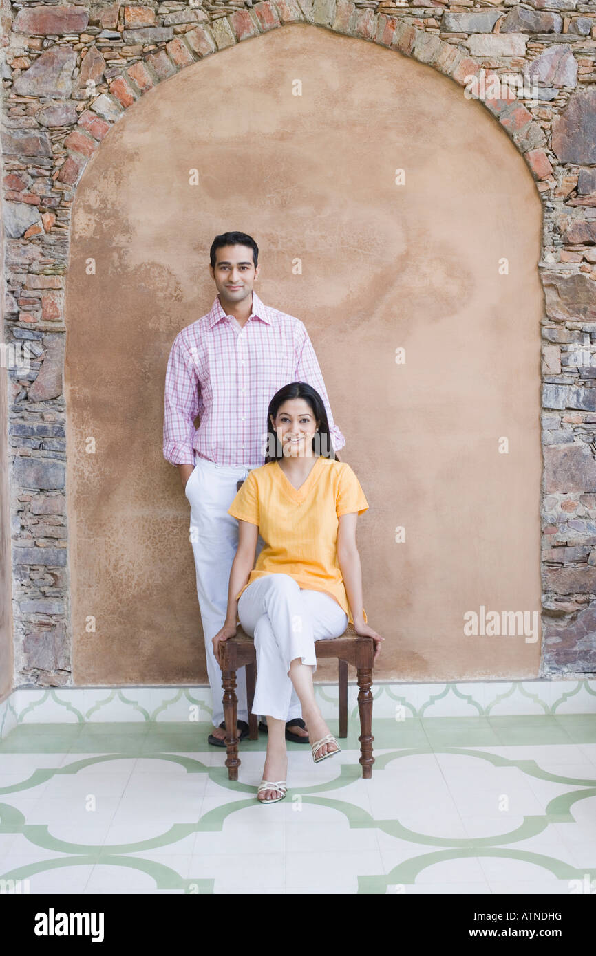 Woman standing behind man sitting High Resolution Stock Photography and ...