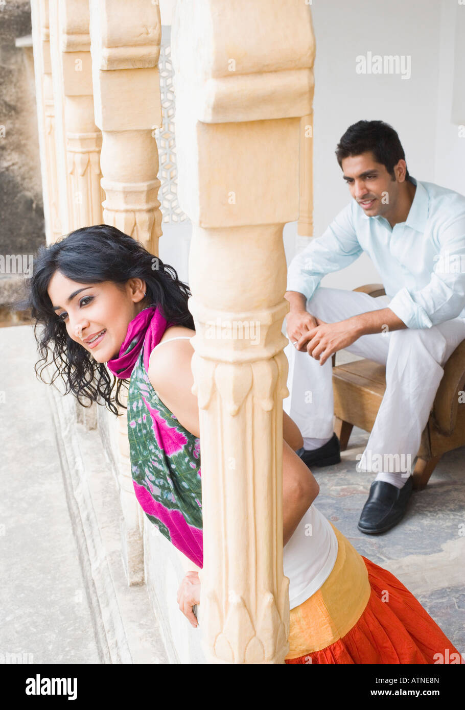 Young woman standing behind column hi-res stock photography and images ...