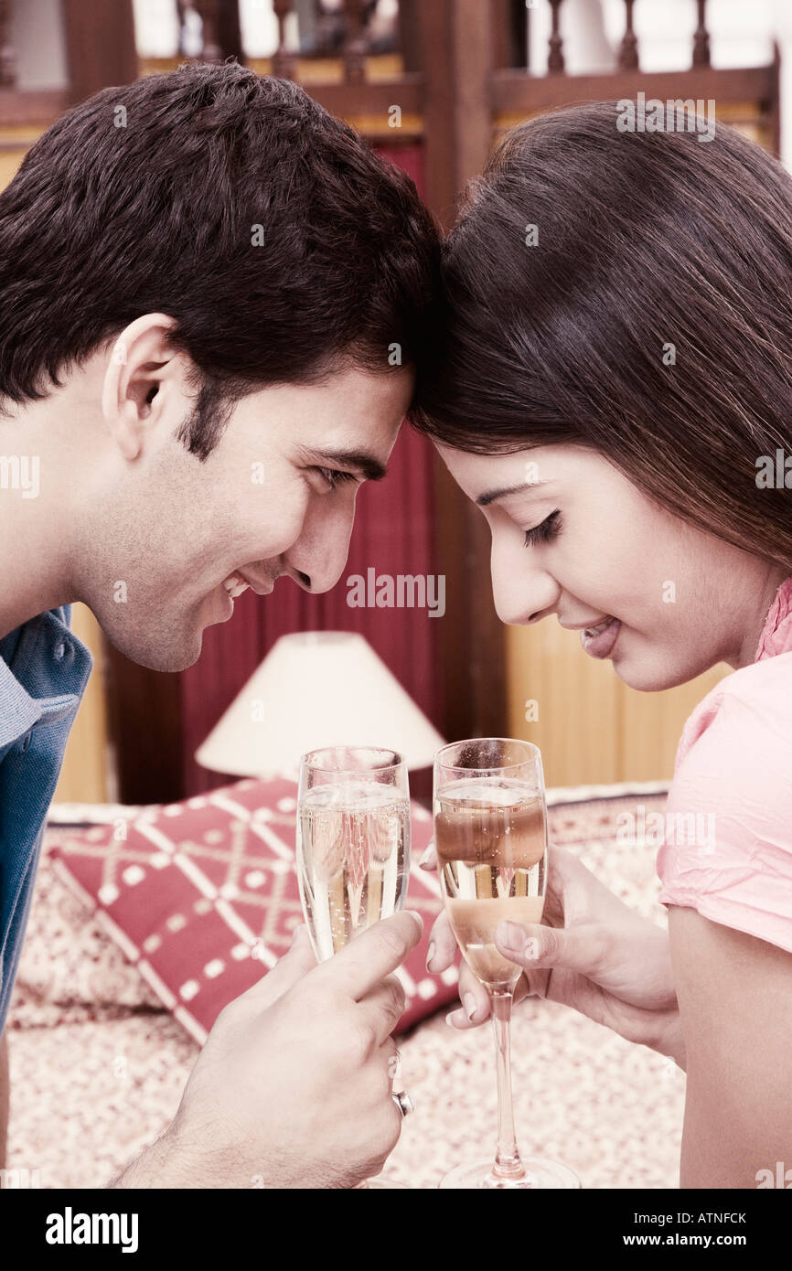 Young couple toasting with champagne flutes Stock Photo - Alamy