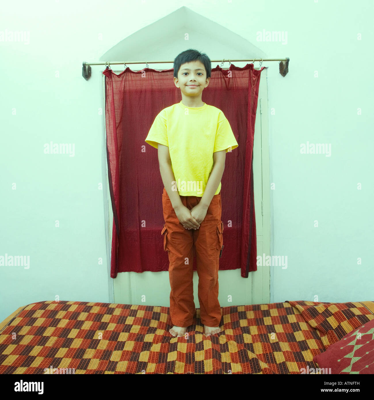 Portrait of a boy standing and smiling Stock Photo - Alamy