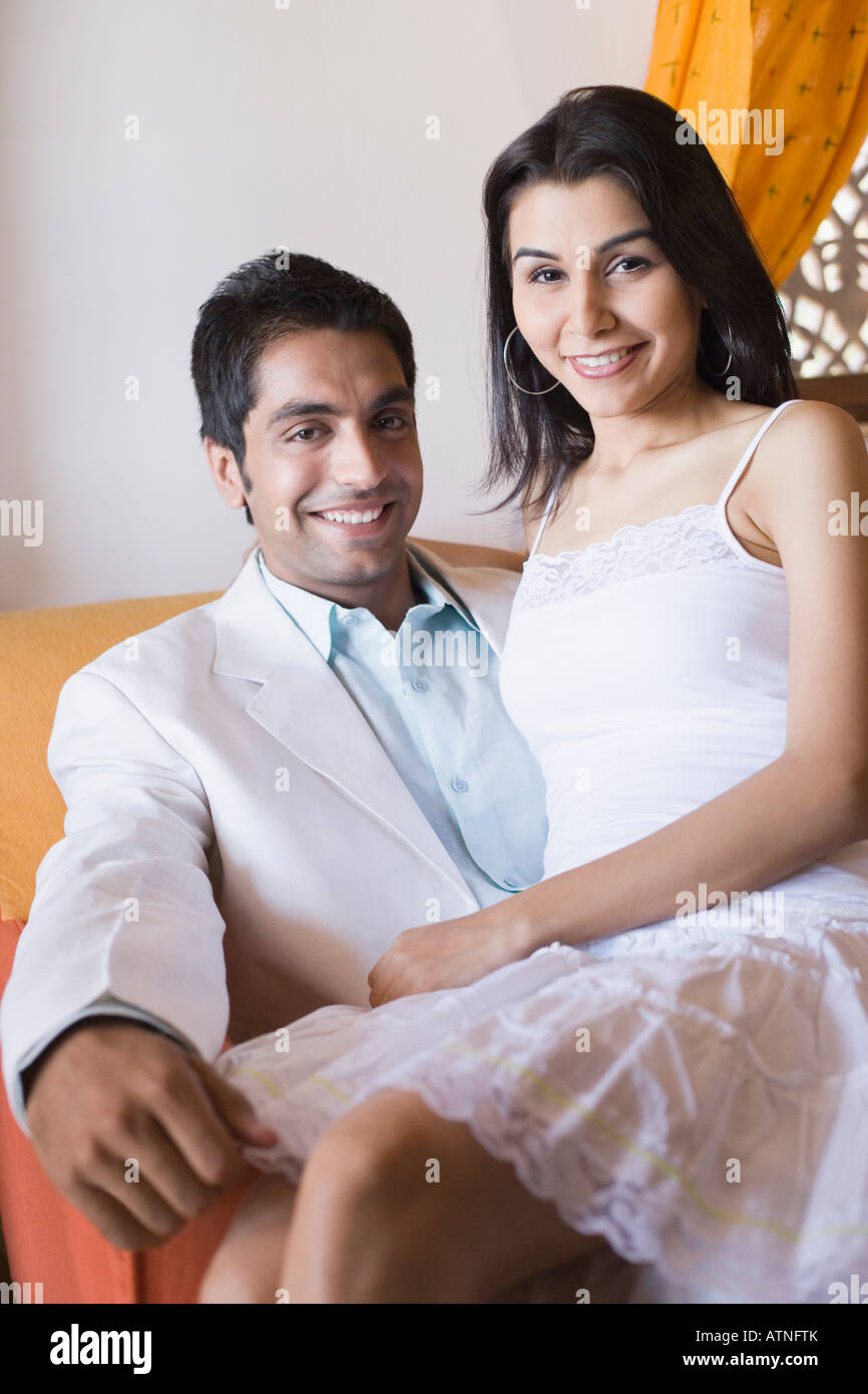Couple on armchair cuddling hi-res stock photography and images - Alamy