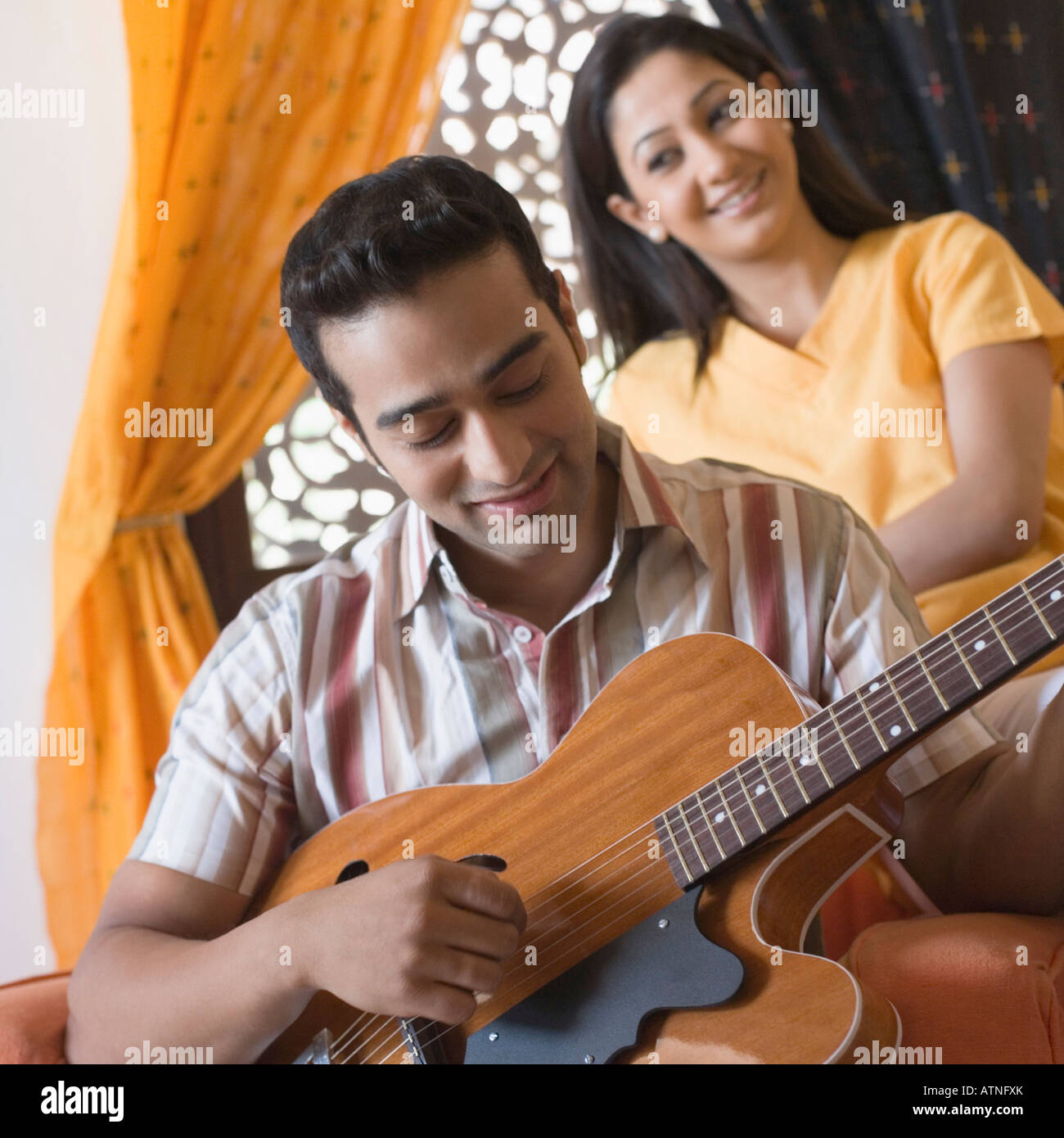 Playing guitar behind head hi-res stock photography and images - Alamy