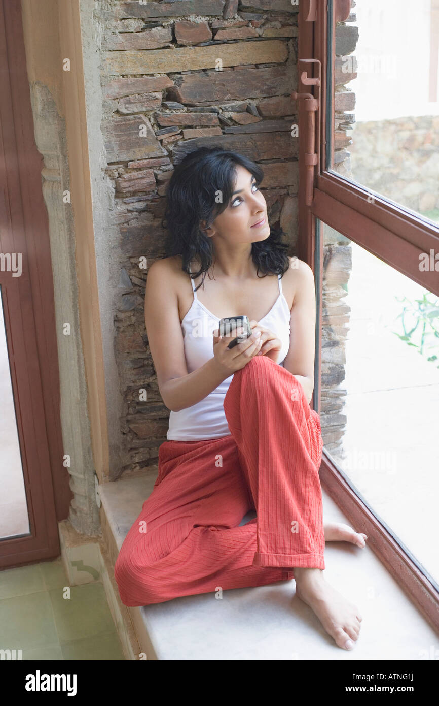 Woman sitting on ledge window hi-res stock photography and images - Alamy