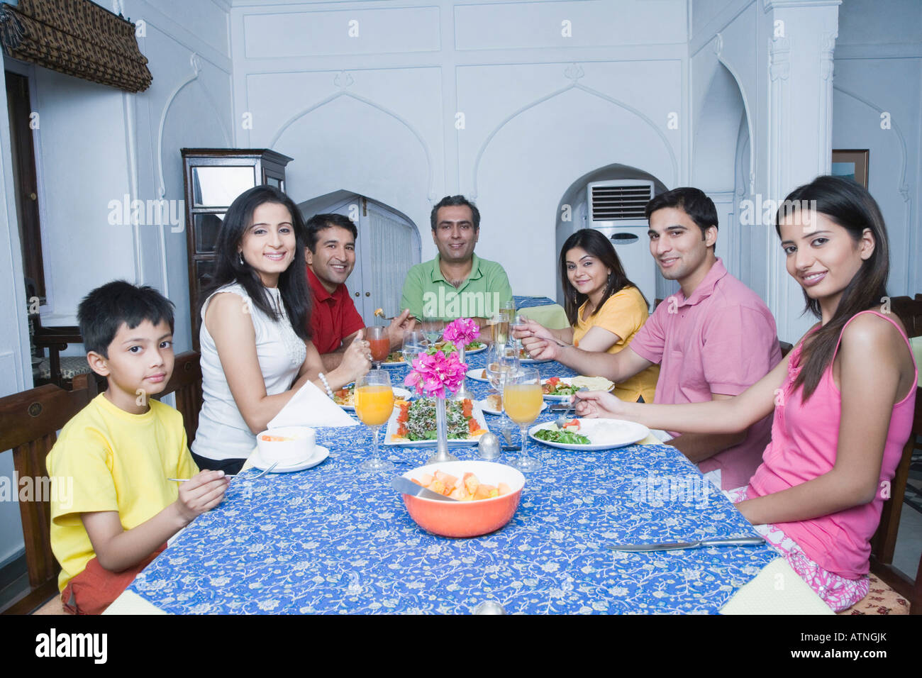 Portrait of a group of people sitting at a dining table Stock Photo - Alamy