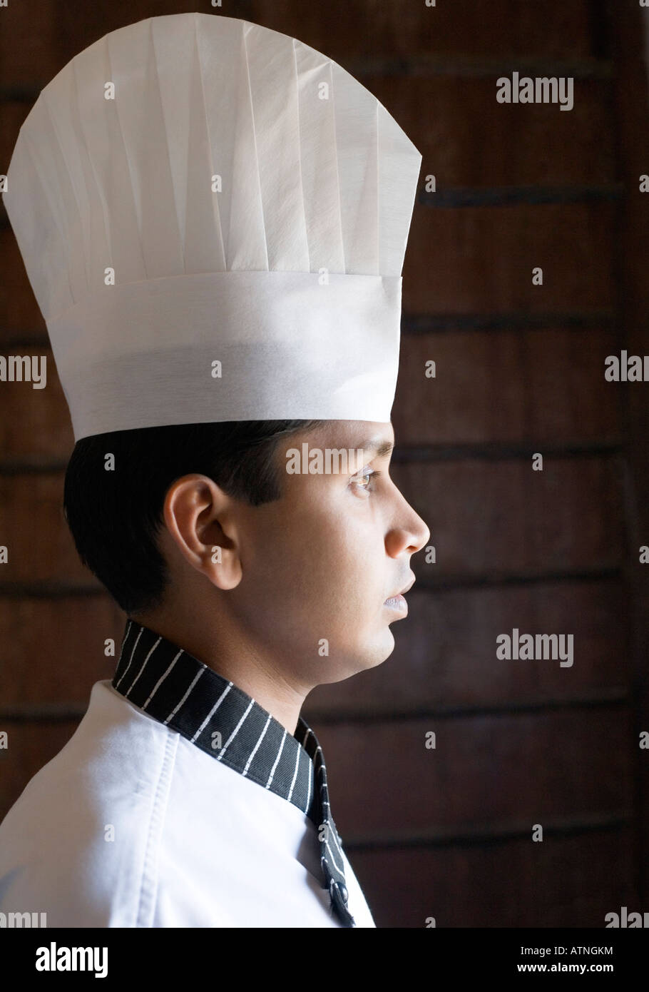 Side profile of a chef in front of a brick wall Stock Photo - Alamy