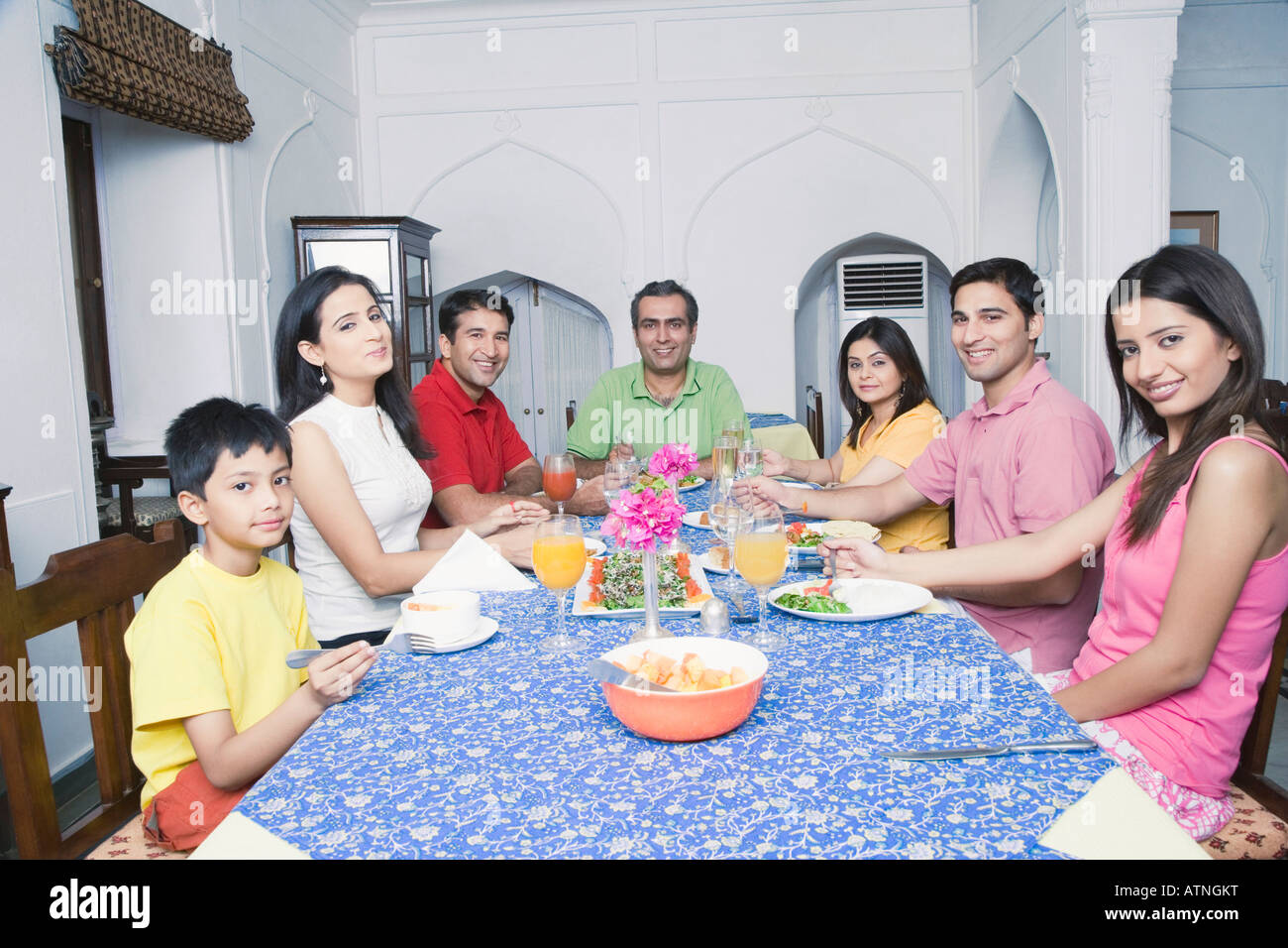 Group of people sitting at a dining table Stock Photo - Alamy