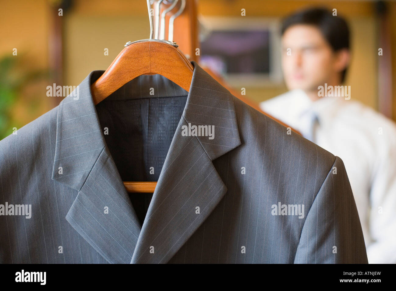 Close-up of a business suit hanging on a clothes rack with a ...