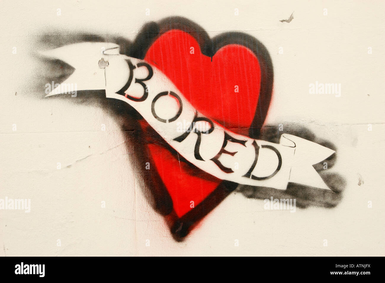 Graffiti painting on wall with heart shape saying "bored" in Cheltenham ...