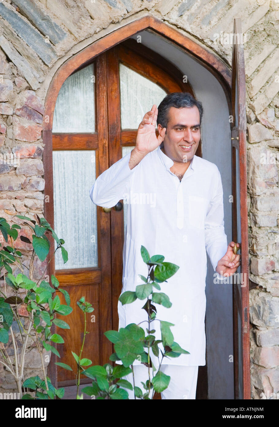 Mid adult man waving his hand Stock Photo - Alamy