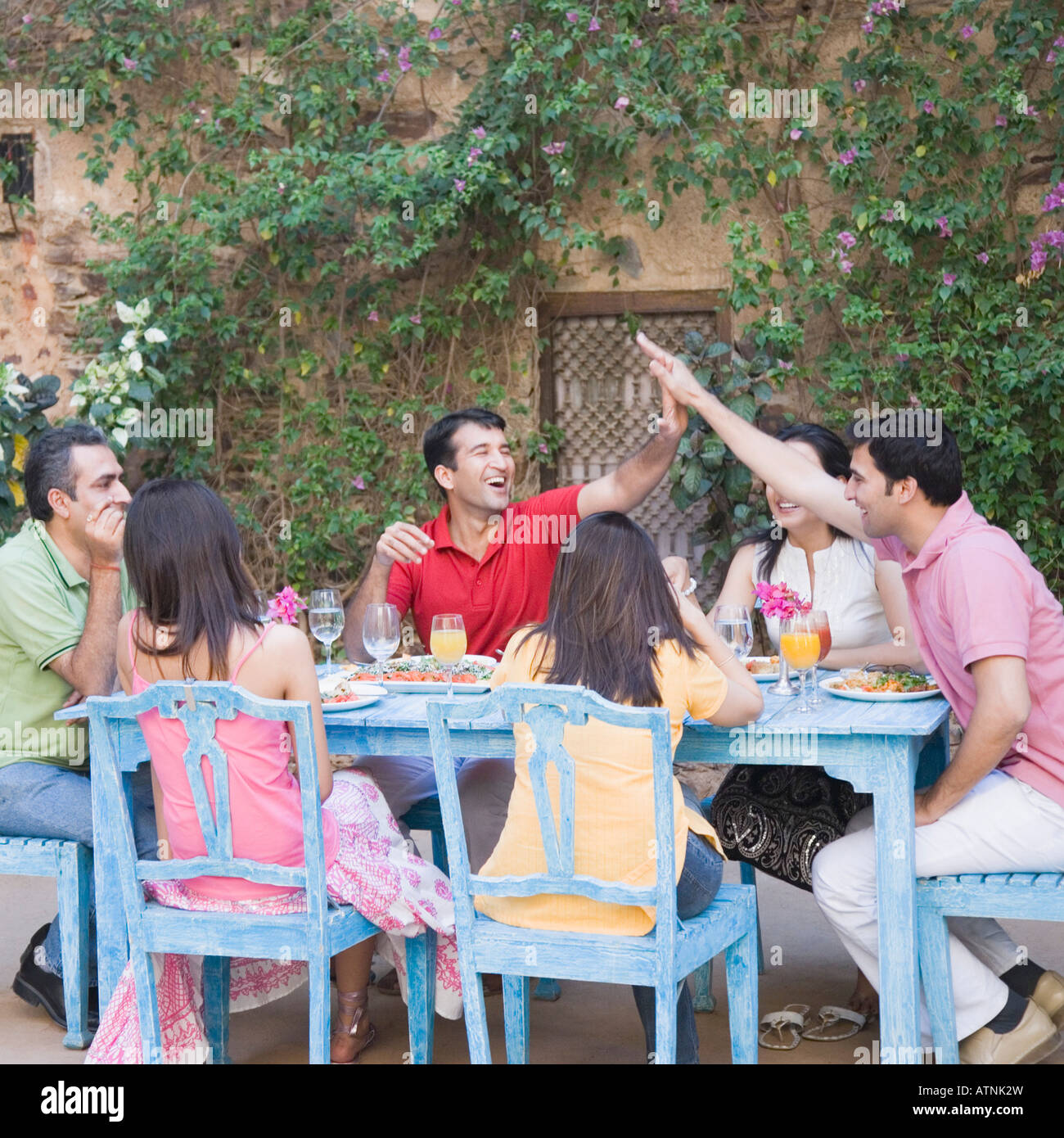 Group of people sitting at a dining table Stock Photo - Alamy