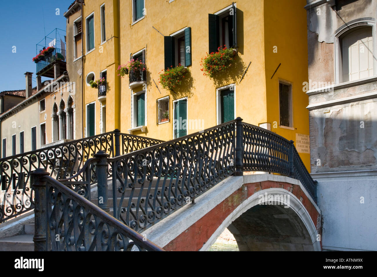 Venice, Veneto, Italy. Colourful house and typical Venetian footbridge ...