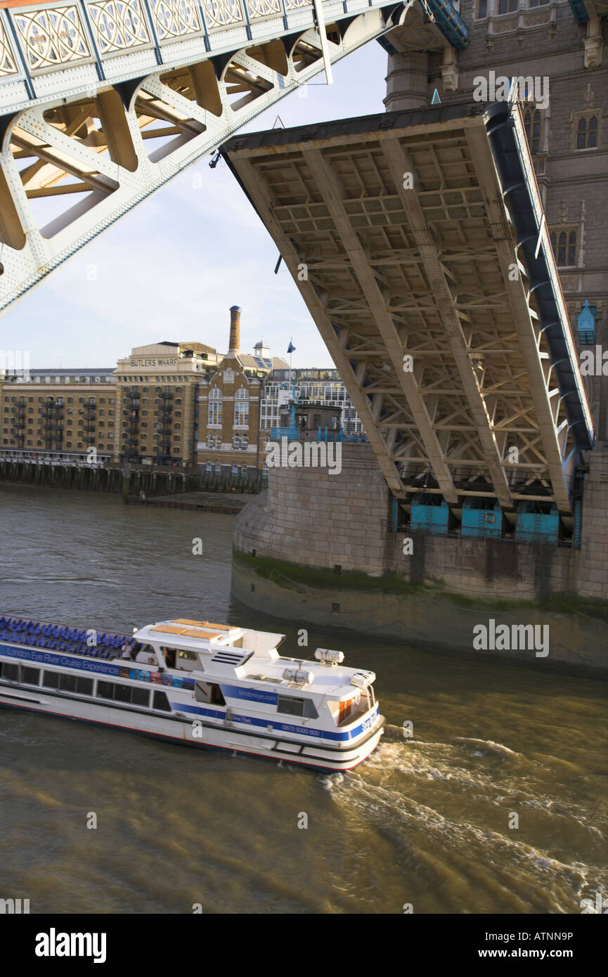 Tower Bridge London raised with passing cruise boat Stock Photo - Alamy