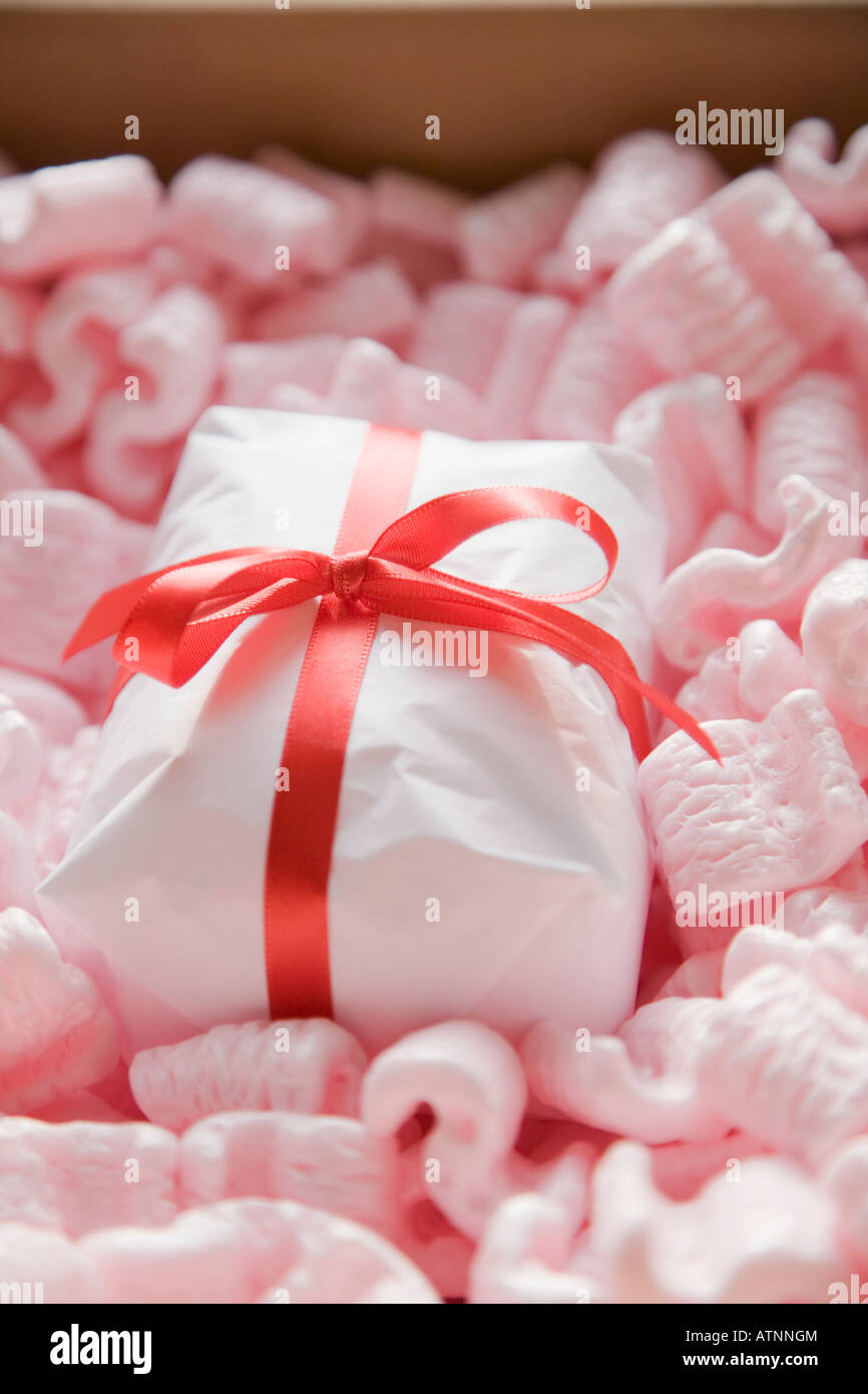Gift in box protected by pink styrofoam Stock Photo - Alamy
