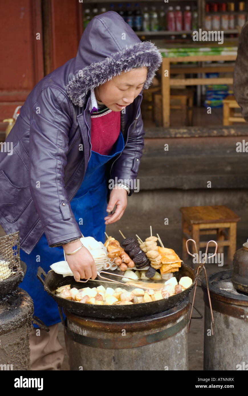 China, Chinese Woman Cooking Food In A Wok Outside, Lijiang Old Town ...