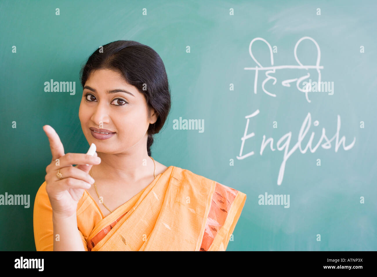 Portrait of a school teacher teaching in a classroom Stock Photo - Alamy