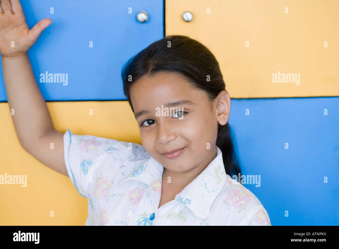 Portrait of a girl smiling with her hand raised Stock Photo - Alamy