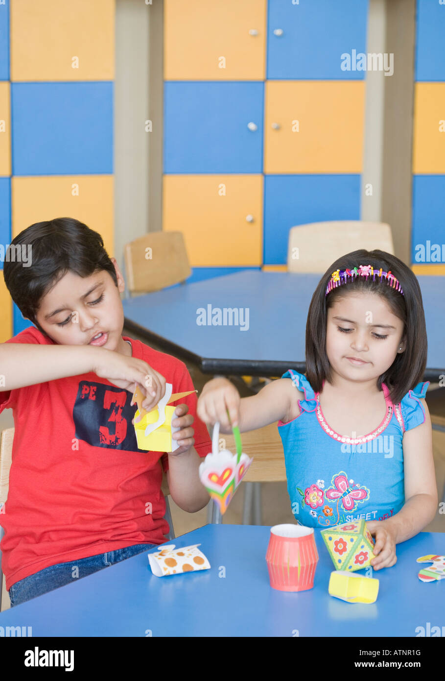 Two students making paper craft products in a classroom Stock Photo - Alamy