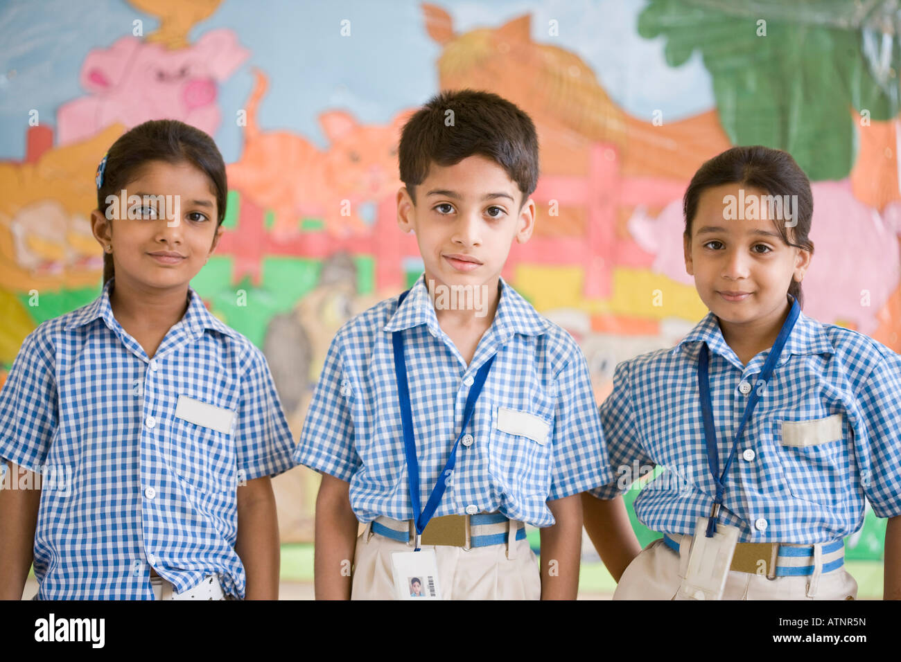 Portrait of three schoolchildren standing in a row Stock Photo - Alamy