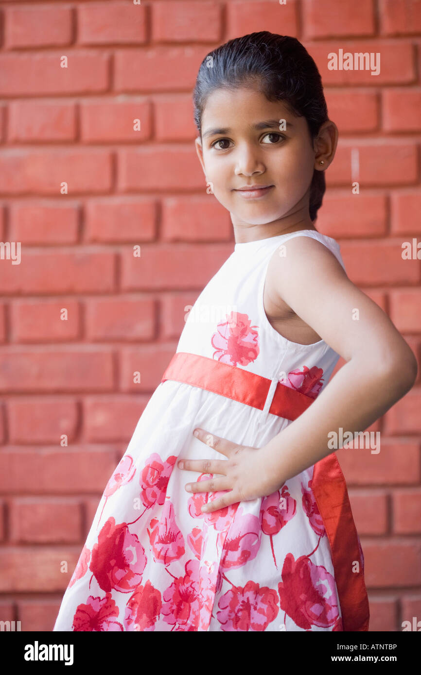 Portrait of a schoolgirl posing in front of a brick wall Stock Photo ...