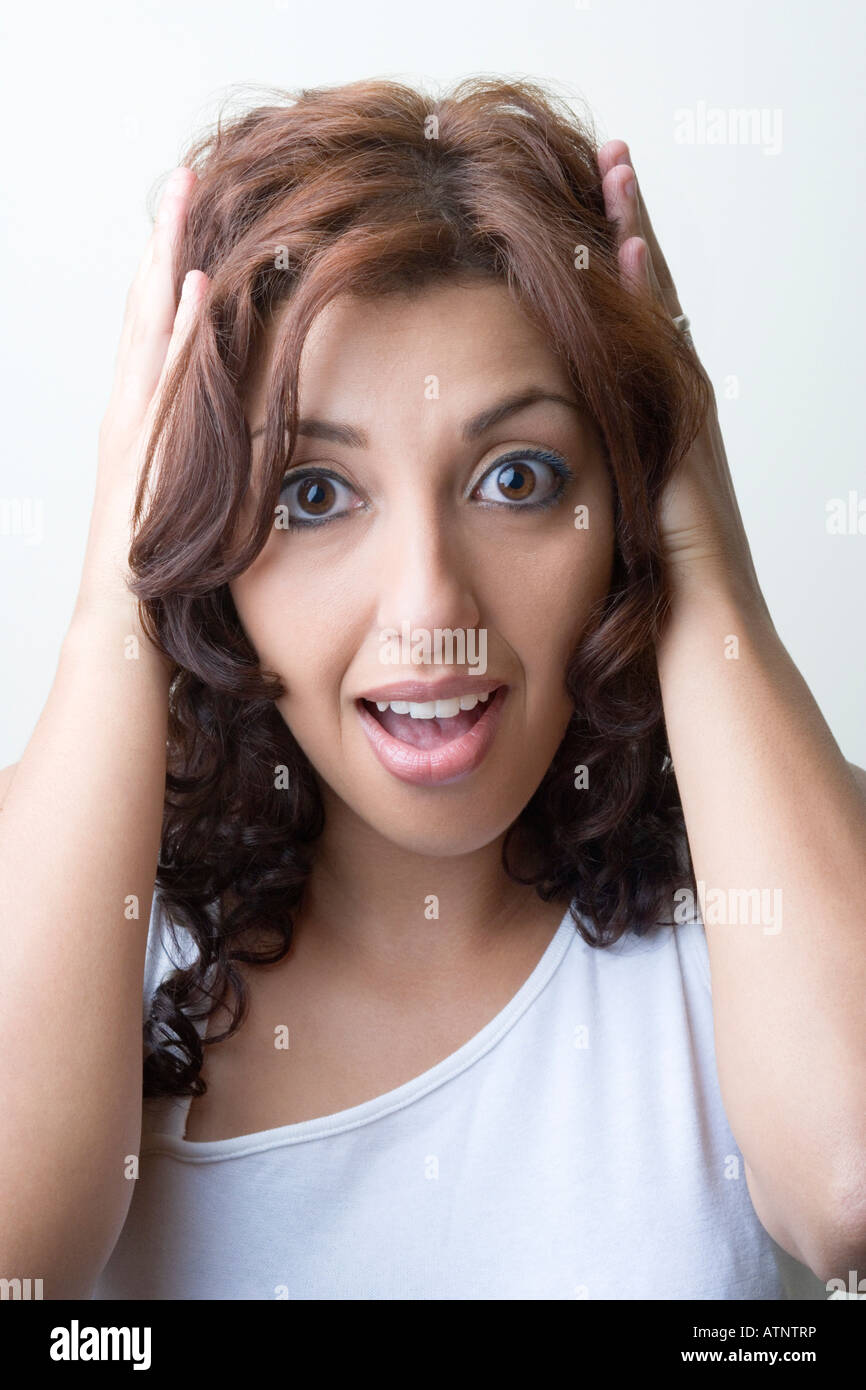 Portrait of a young woman looking surprised Stock Photo - Alamy