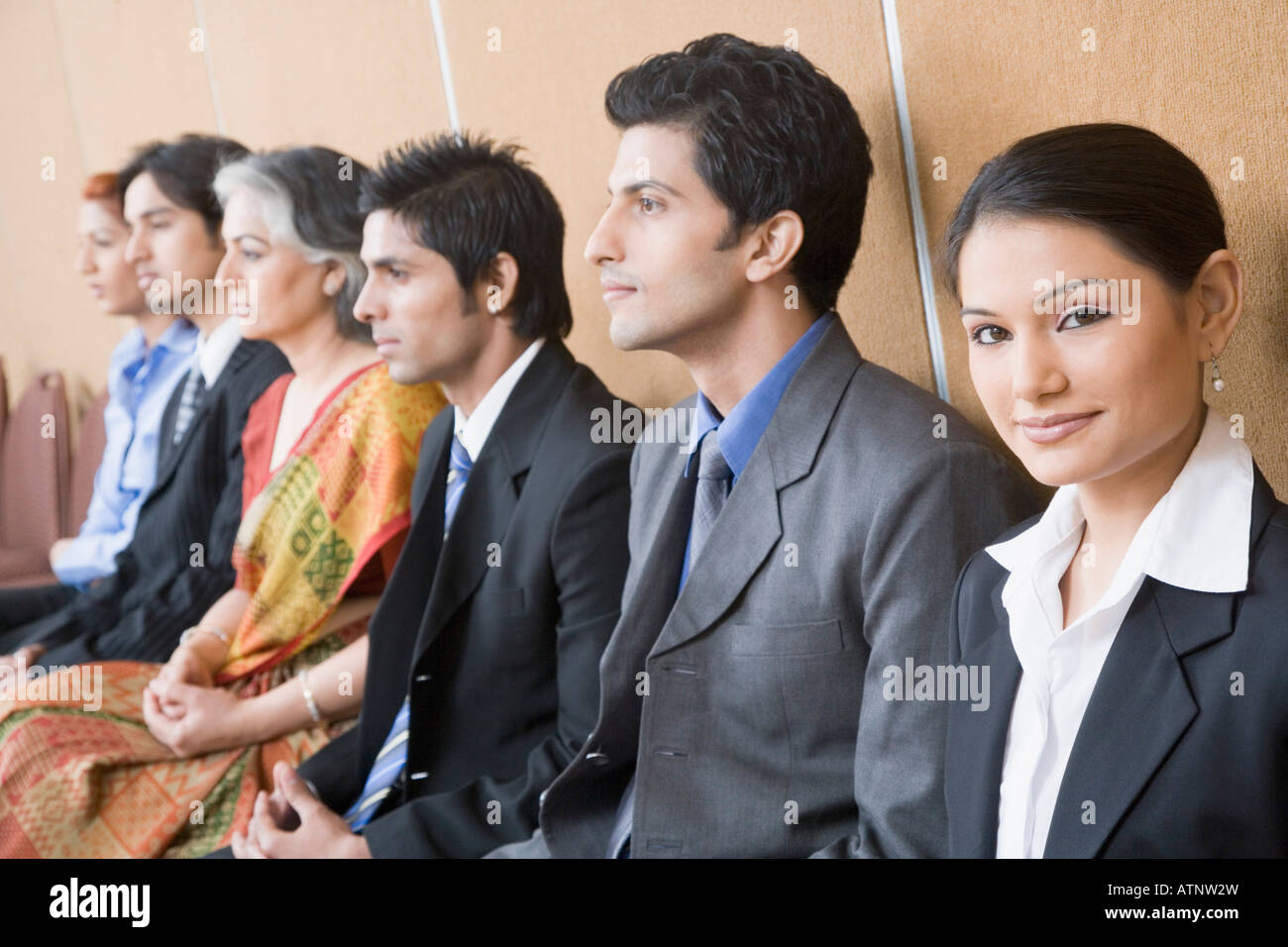 Portrait of a businesswoman sitting with five business executives and ...