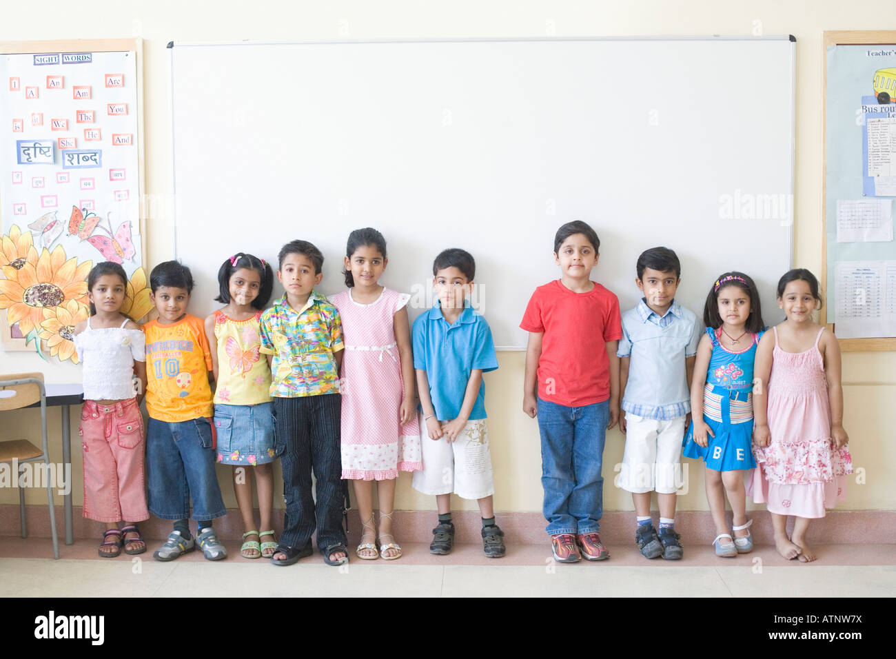 Children standing in front of the whiteboard in a classroom Stock Photo ...