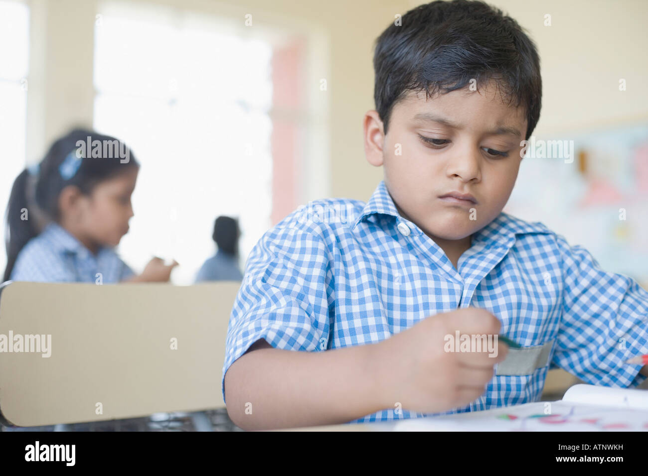 Close-up of a schoolboy coloring his drawing on a notepad Stock Photo ...