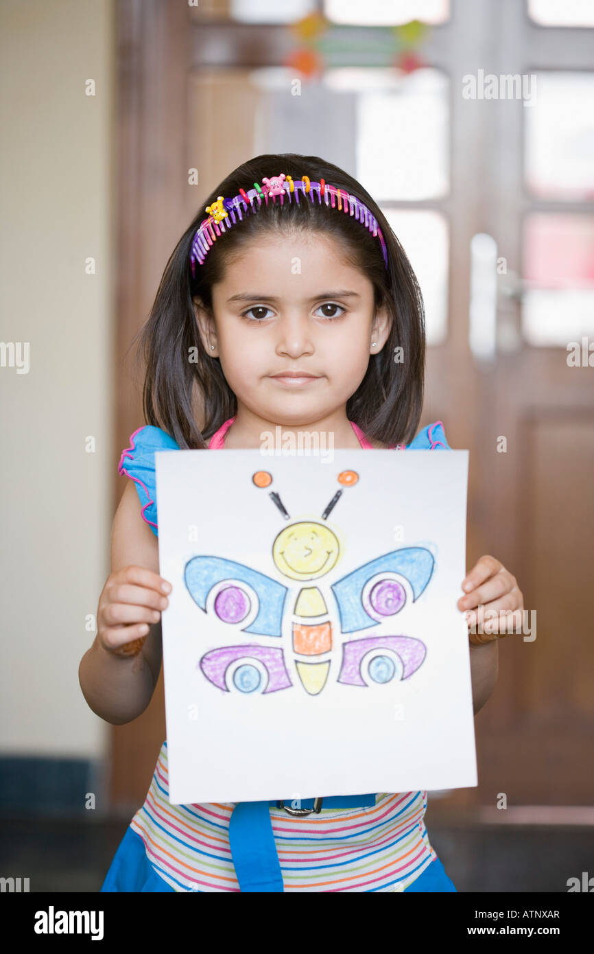 Portrait of a girl showing her drawing Stock Photo - Alamy